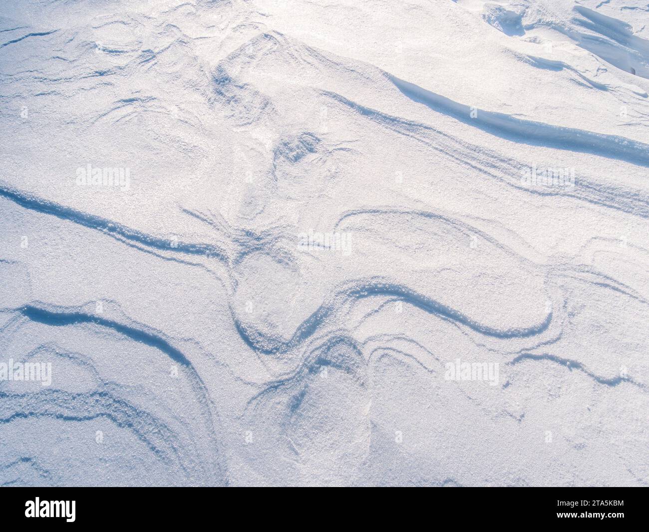 Snow texture with waves created by wind erosion Stock Photo - Alamy