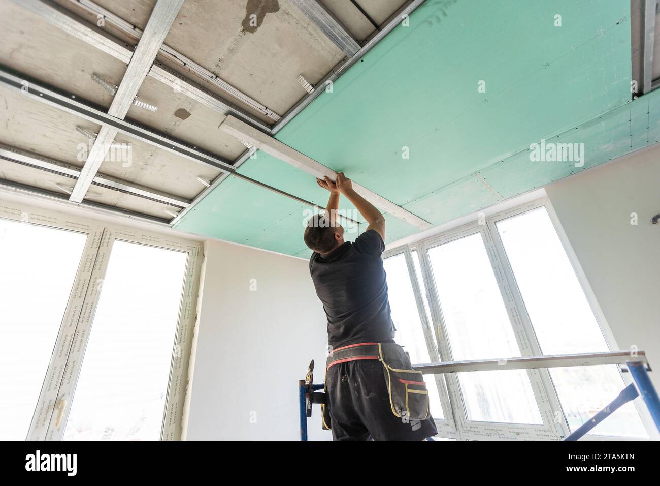 Man fasten ceiling profiles in hi-res stock photography and images - Alamy