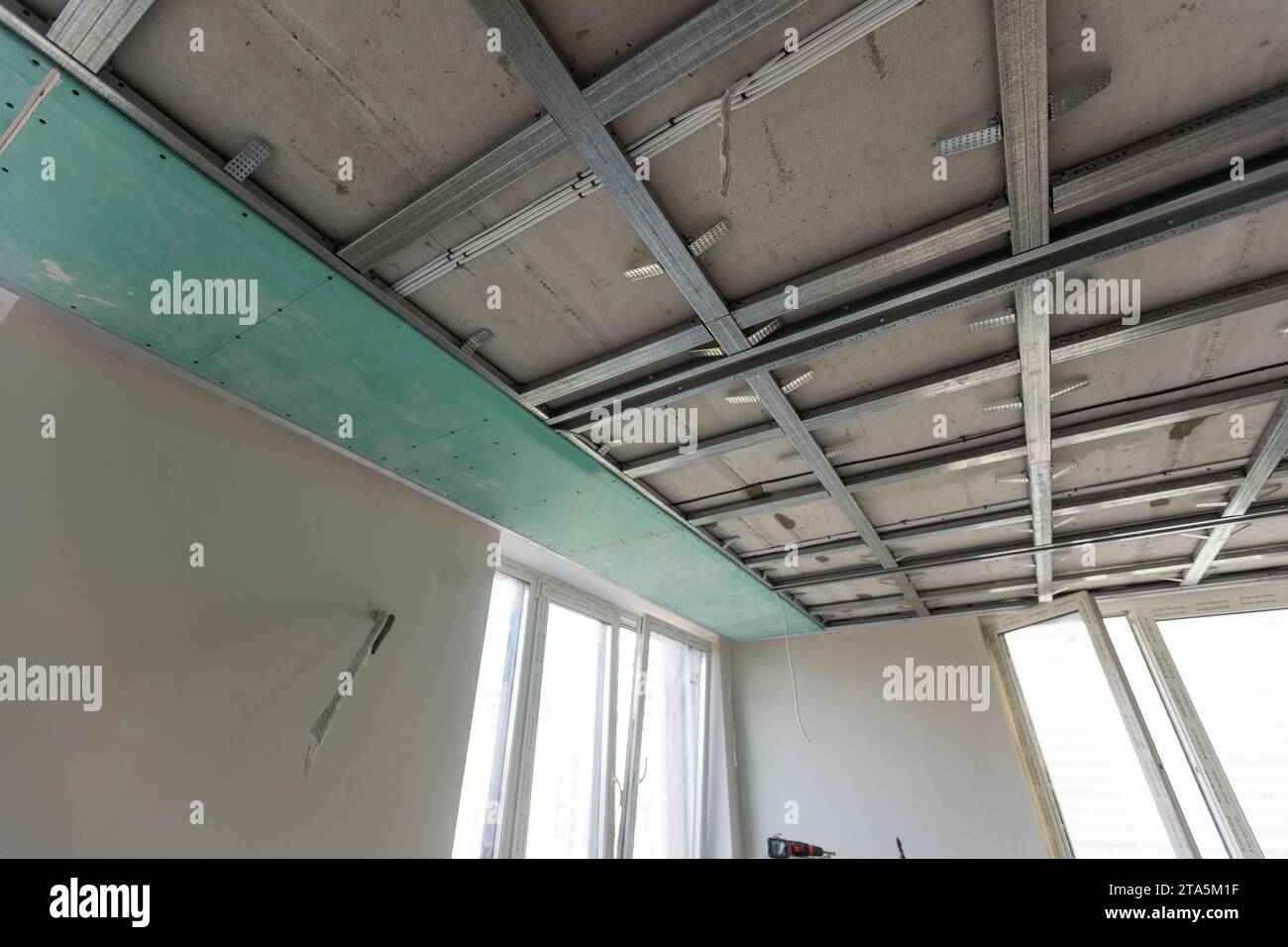 Construction worker installation ceiling work Stock Photo - Alamy