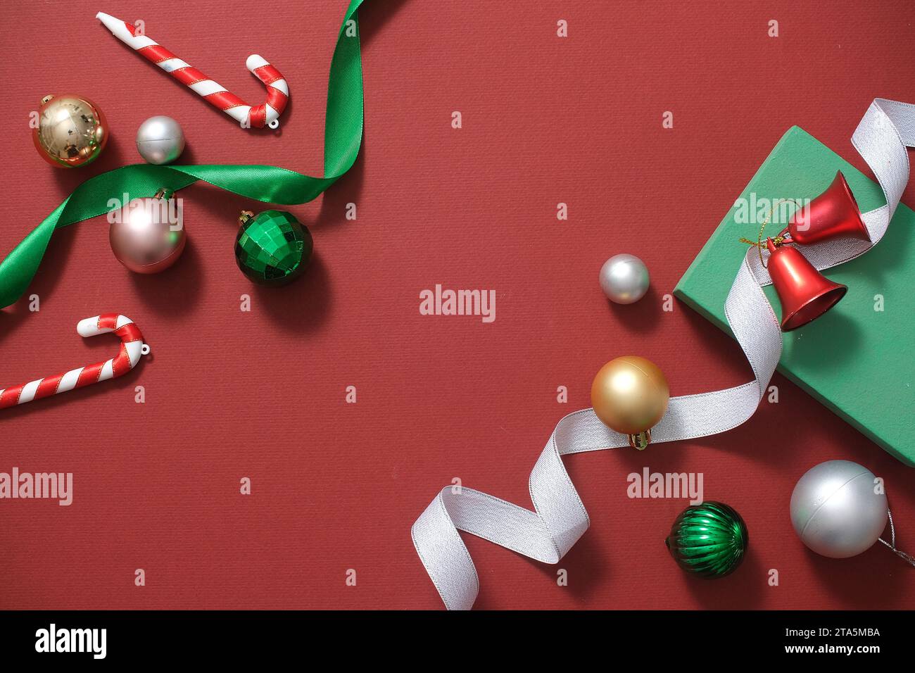 Top view of cute baubles, candy canes, bells and green ribbons ...