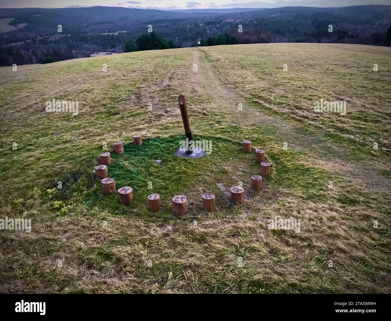 A sundial in a clearing made of wood Stock Photo - Alamy