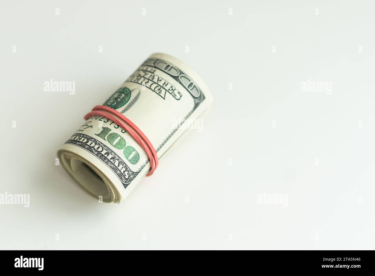 Roll of money isolated on white background Stock Photo - Alamy