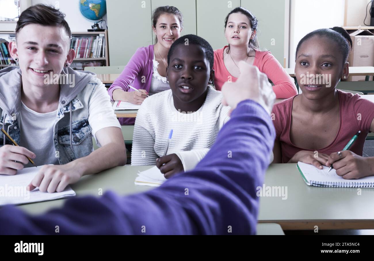 Teacher calls student at far desk Stock Photo - Alamy