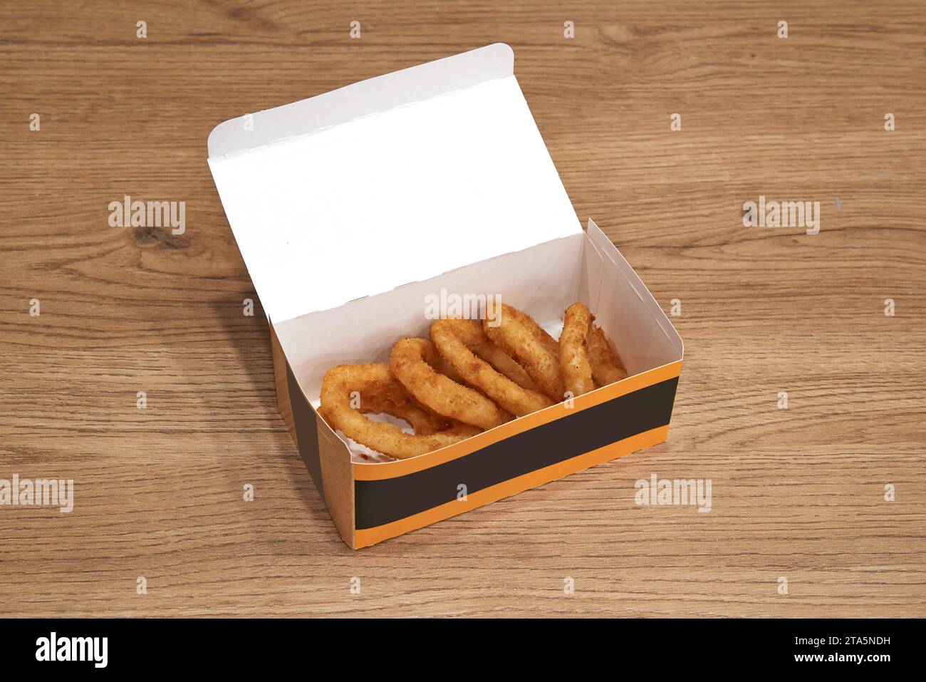 Delivery craft box with fried appetizer on wooden table Stock Photo - Alamy