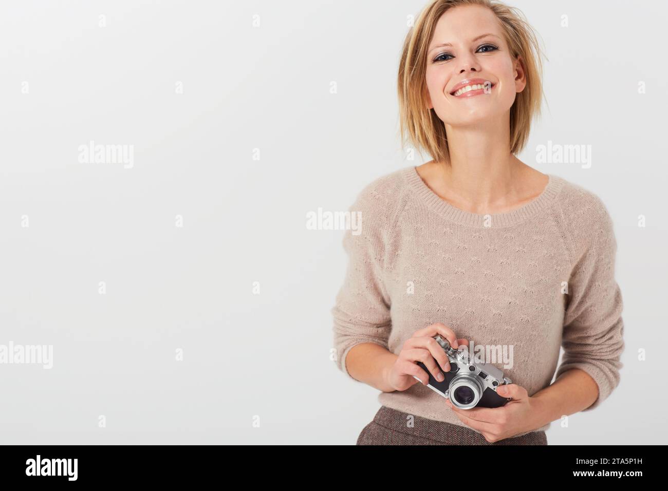 Portrait, happy woman and camera for photography in studio with mock up ...