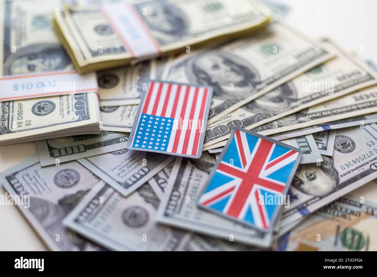 Flag of United Kingdom sticking in a variety of american banknotes ...