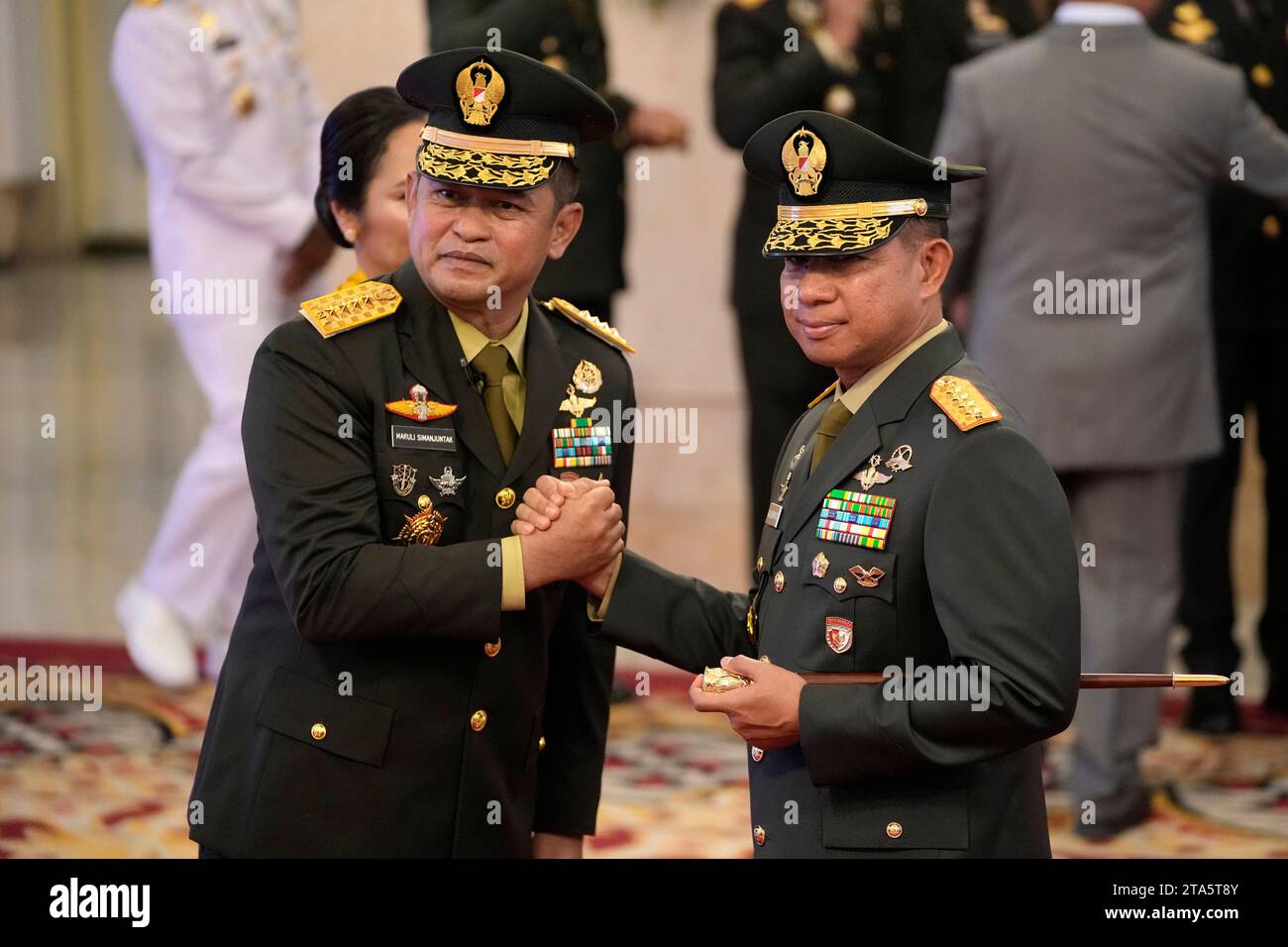 Indonesia's newly-inaugurated Army Chief Gen. Maruli Simanjuntak, left ...