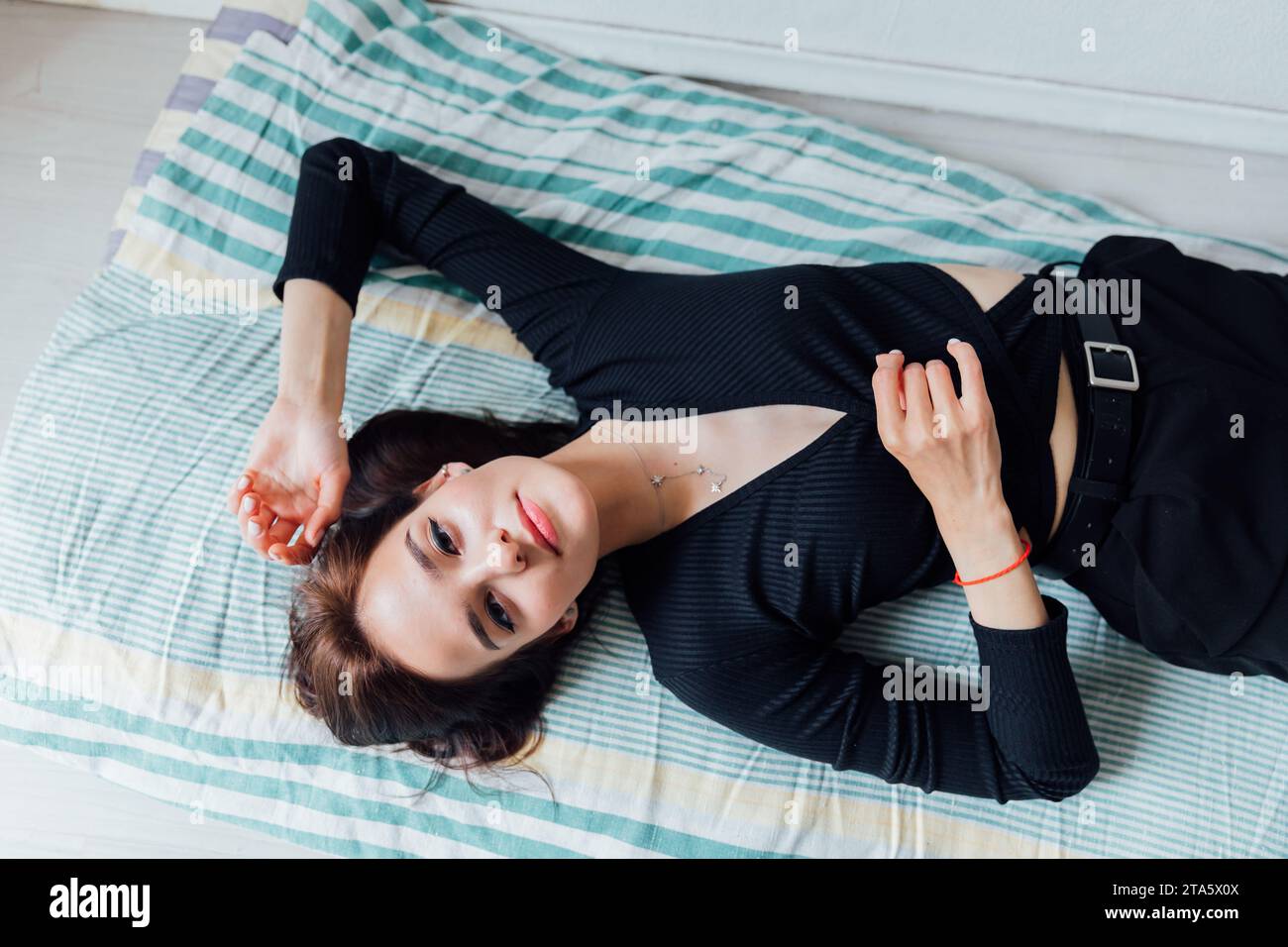 Beautiful woman lying on sleeping mattress on the floor Stock Photo - Alamy