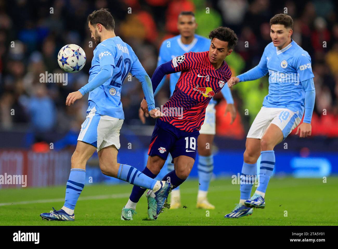 Bernardo Silva #20 of Manchester City takes the ball from Fabio Carvalho #18 of RB Leipzig ...