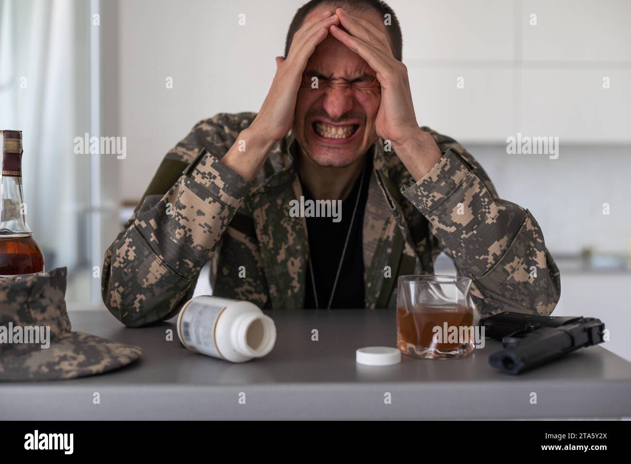 Handsome young soldier wearing uniform suffering from stress, screaming ...