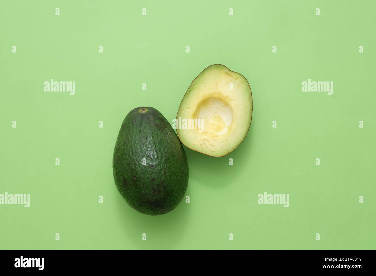 Top view of two slices of avocado isolated on green background ...