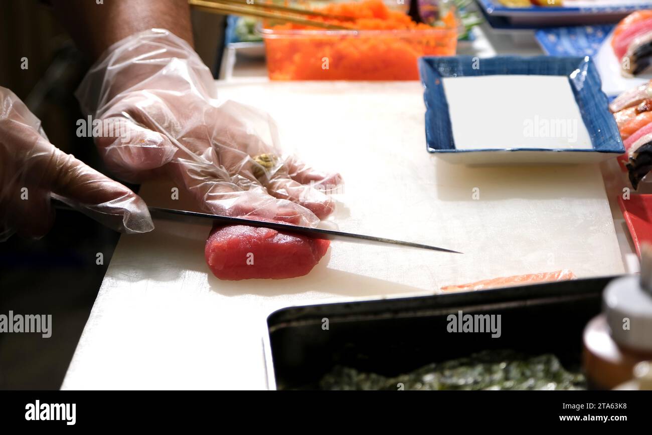 Chef use sharp knife slicing Tuna red fish for sashimi. Enjoy Omakase ...