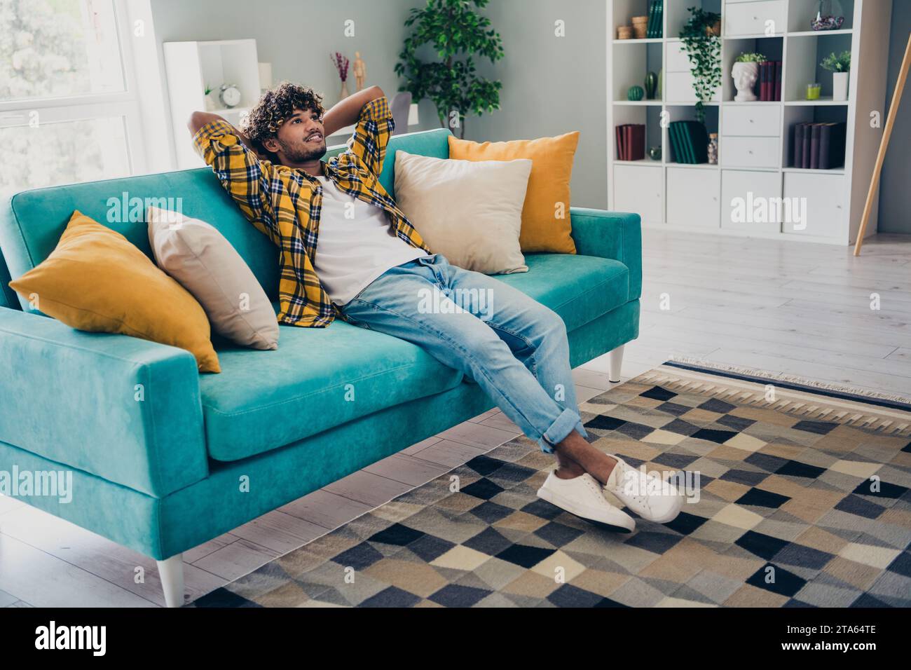 Full body photo of minded cheerful person sit couch hands behind head ...