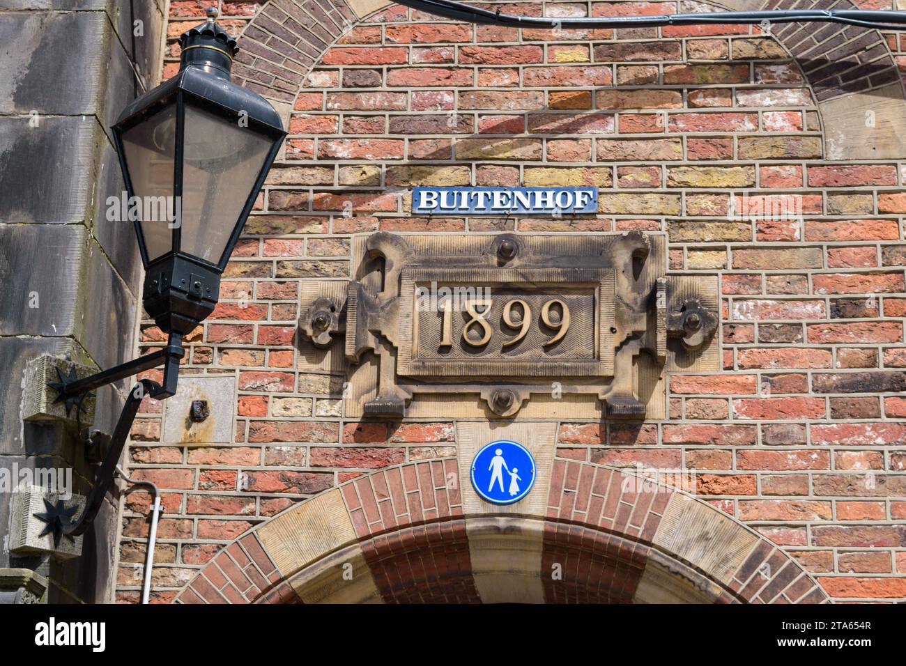 The street sign Buitenhof above the pedestrian entrance gate leading to ...