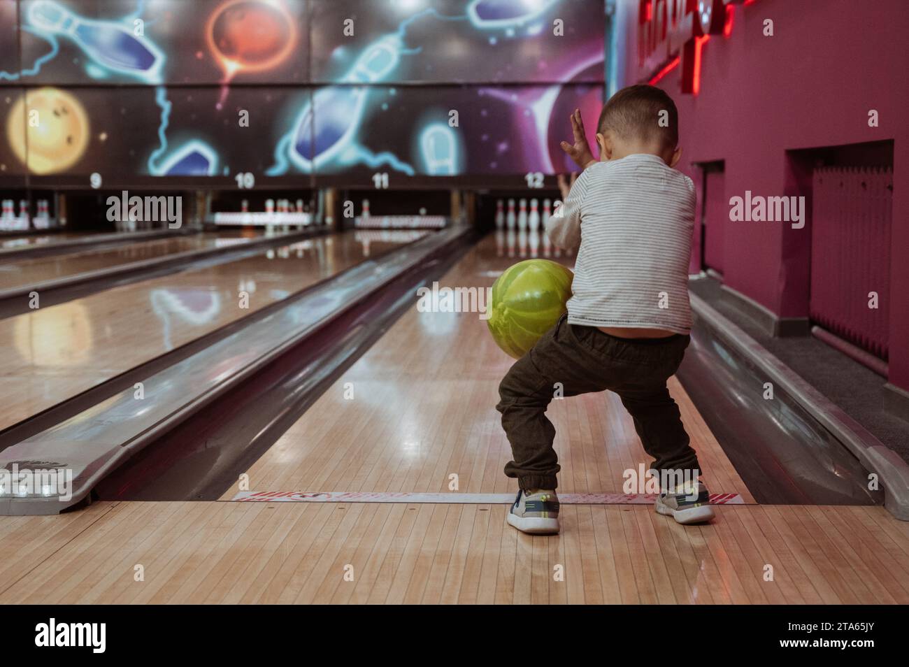 little child boy playing bowling in a club Stock Photo - Alamy