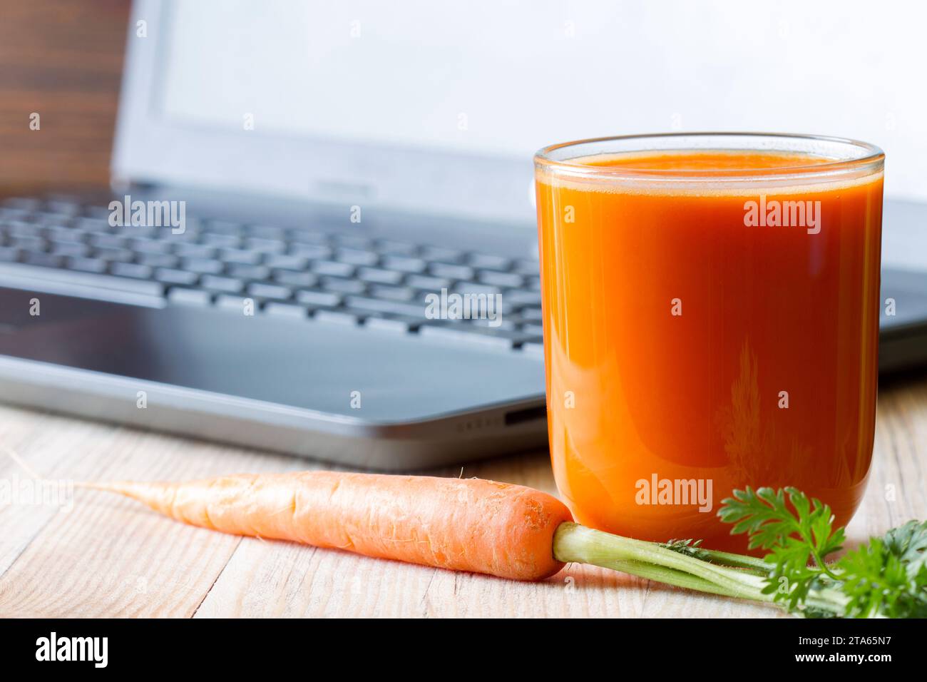 Carrot juice and laptop. Caring for eyesight while working with ...