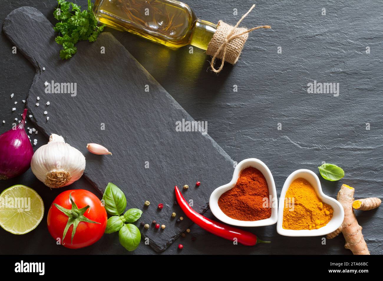 Cooking background. Vegetables, herbs and spices on black slate Stock ...