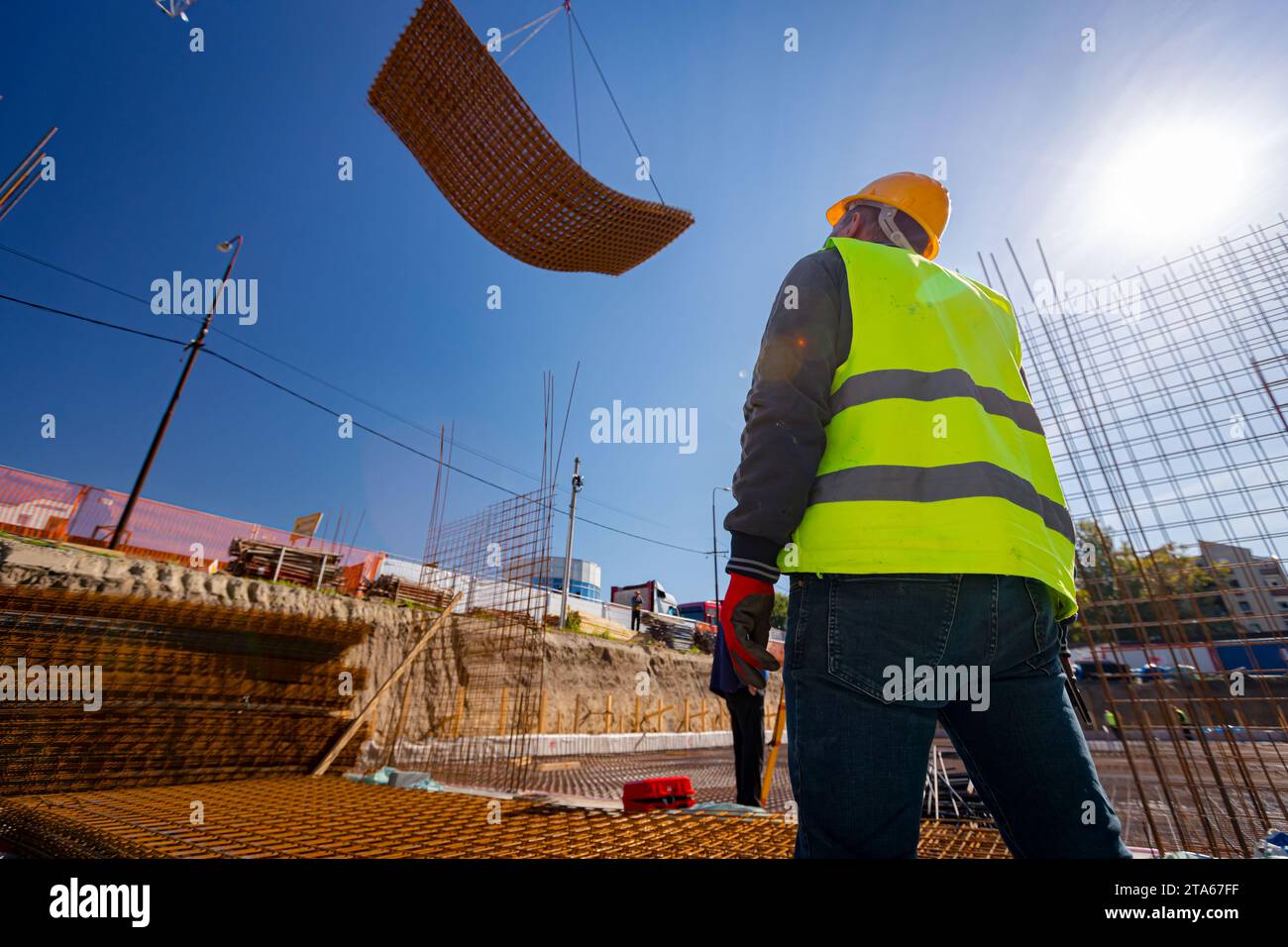 Worker with safety helmet watch and wait delivery by crane as carry ...