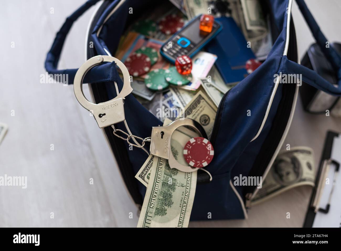 Handcuffs on many stacks of dollar bills. Metal suitcase with money ...