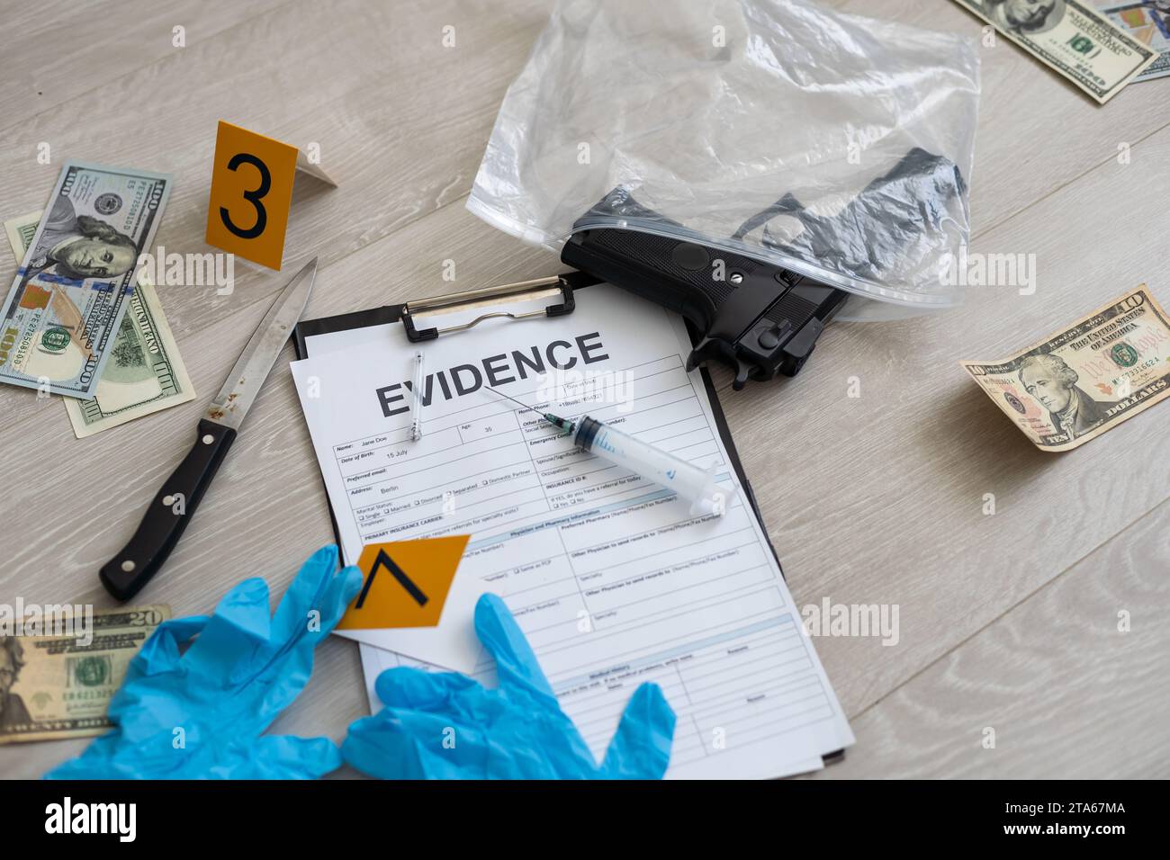 Evidence markers with knife and magazine of gun on the ground. Sign of ...