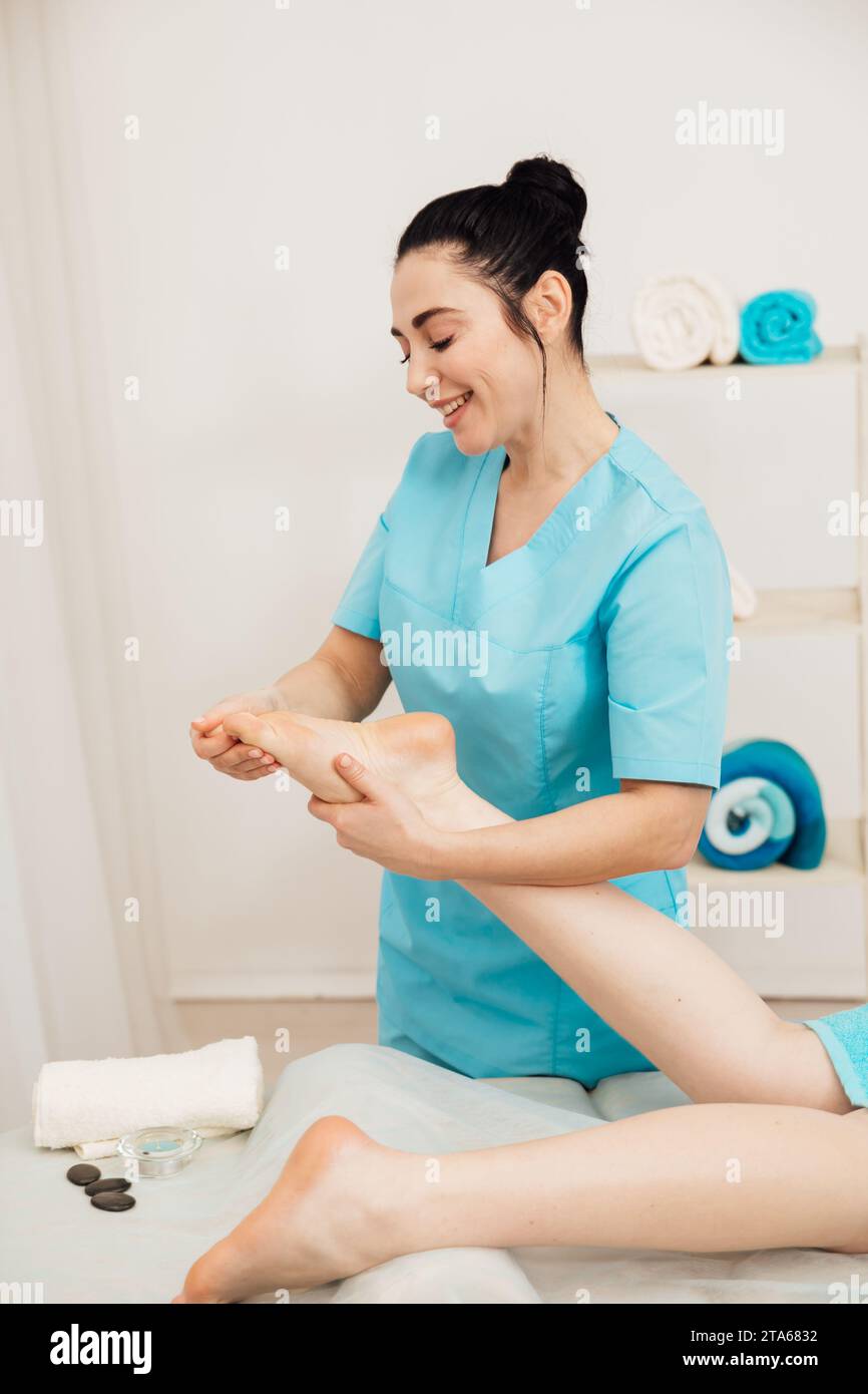 Female masseur doing therapeutic medical foot massage in spa Stock ...
