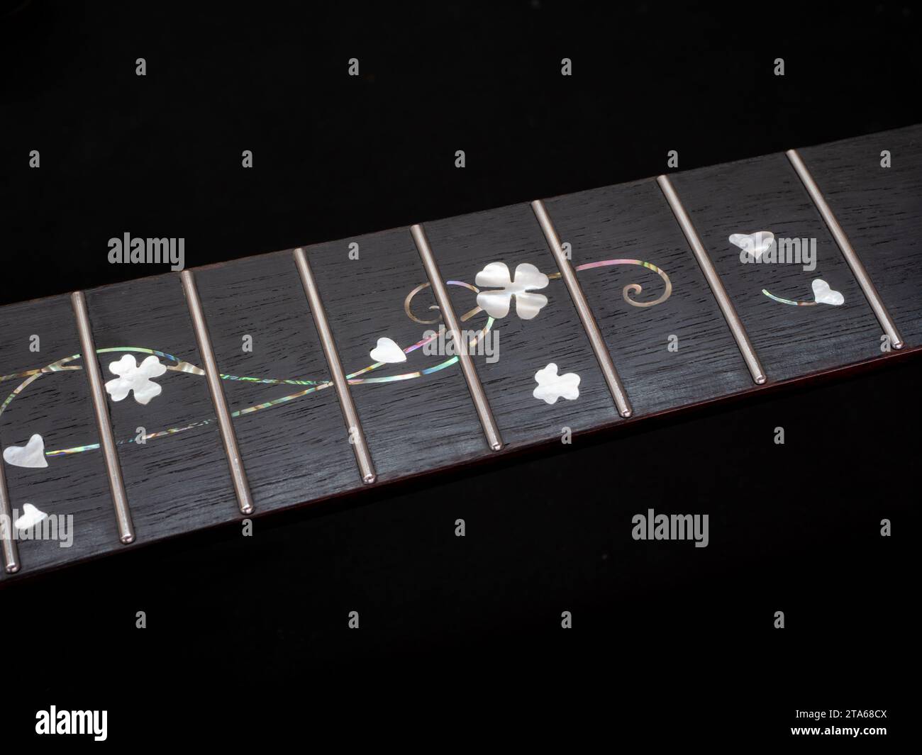 close up shot finger board pearl inlay , heart and flower , acoustic ...
