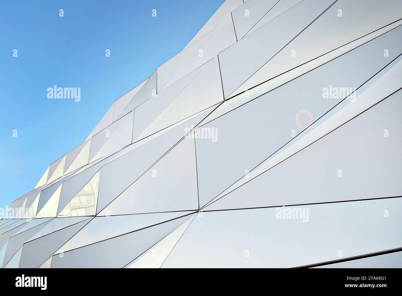 Modern office building with white metallic panel facade and windows ...