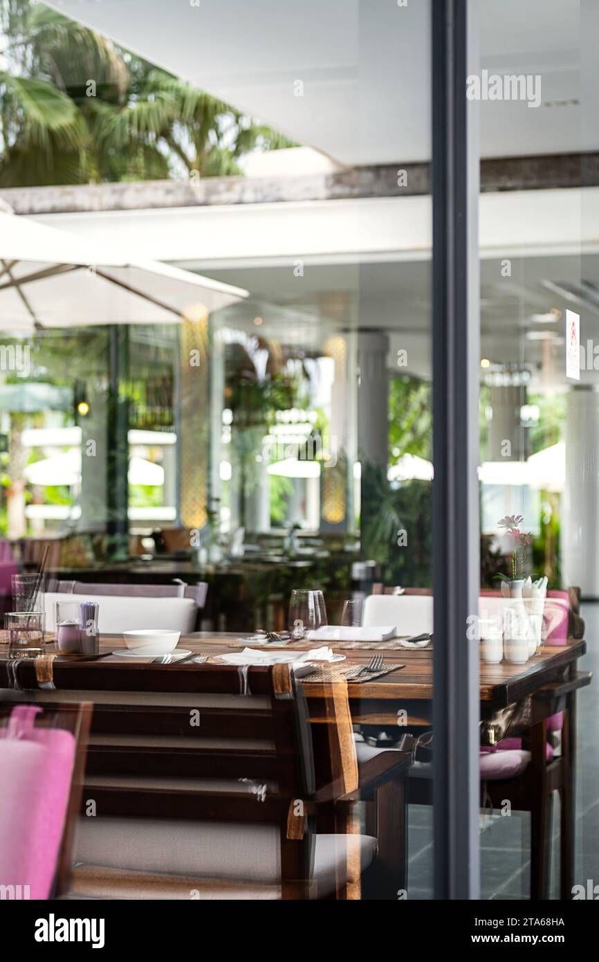 Hotel restaurant space with tables set for dinner at luxury resort ...