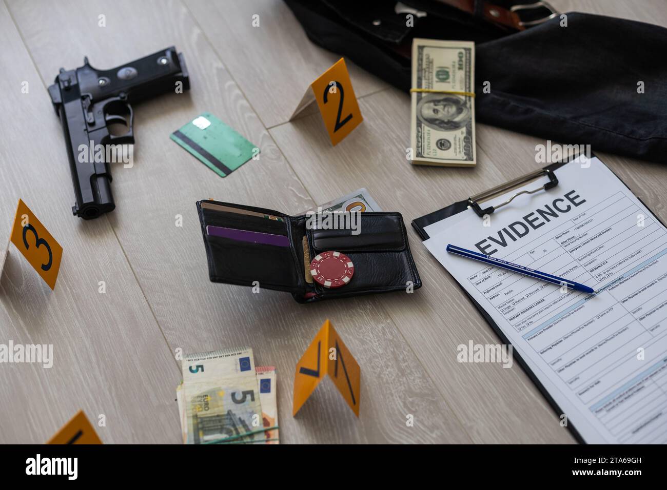 High contrast image of a crime scene with gun and markers on the floor ...