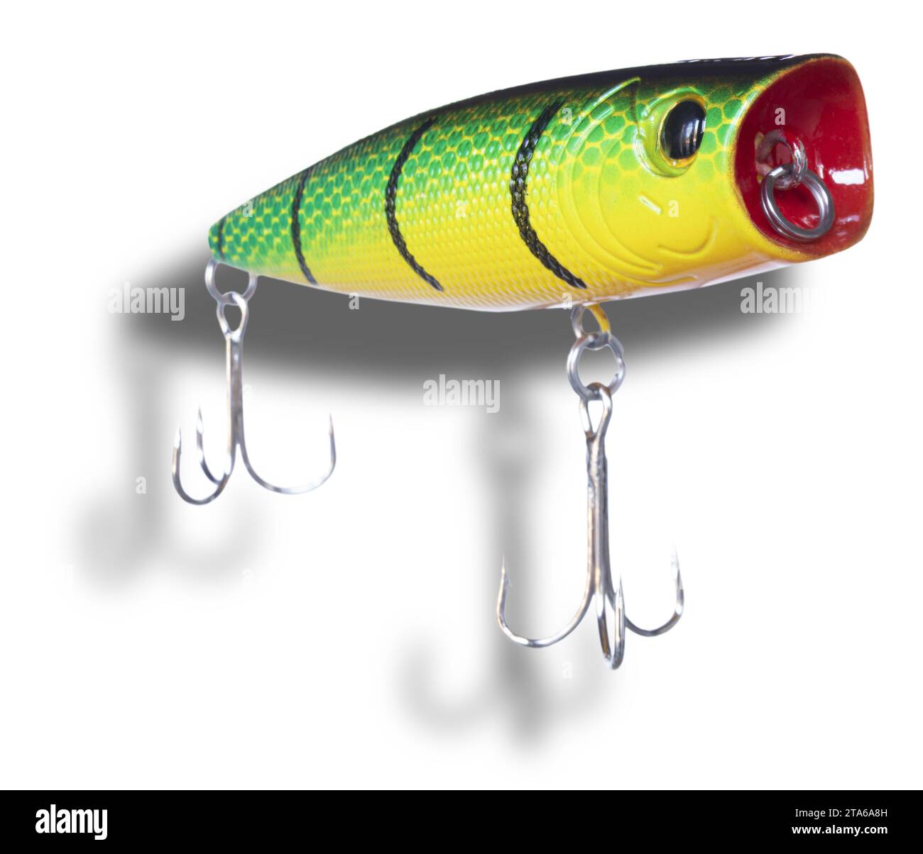 Drop shadow behind two treble hooks undernearth a fake topwater fishing ...
