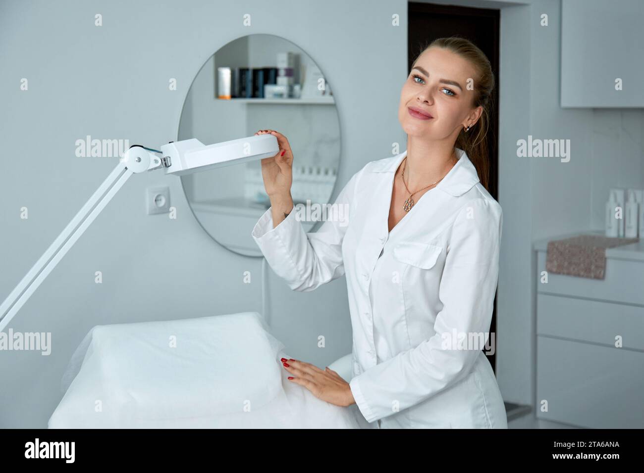 Consultation in cosmetology clinic. Female beauty doctor in white coat ...