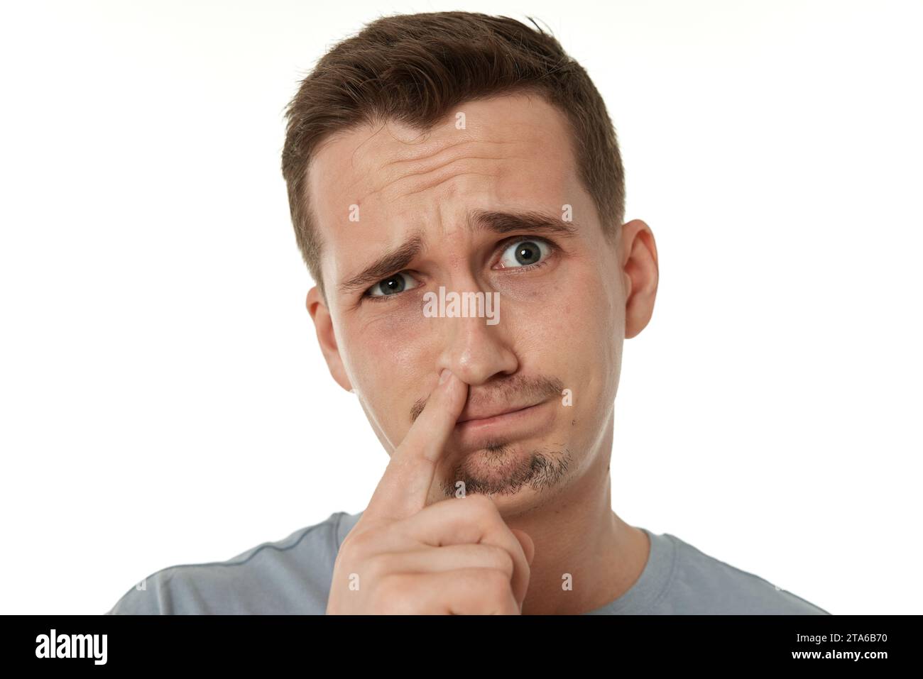 man is picking his nose isolated on white background Stock Photo - Alamy