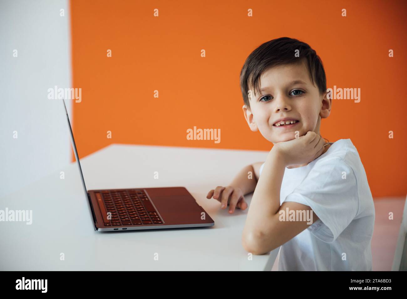 Smart Young Boy Works on a Laptop For His New Project in His Computer ...