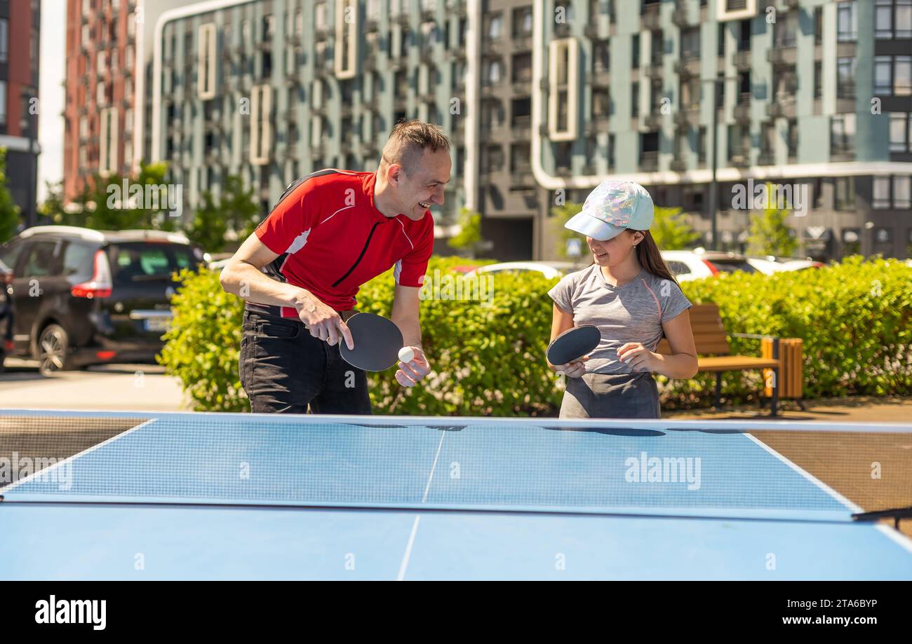 Family playing table tennis outside house Stock Photo - Alamy