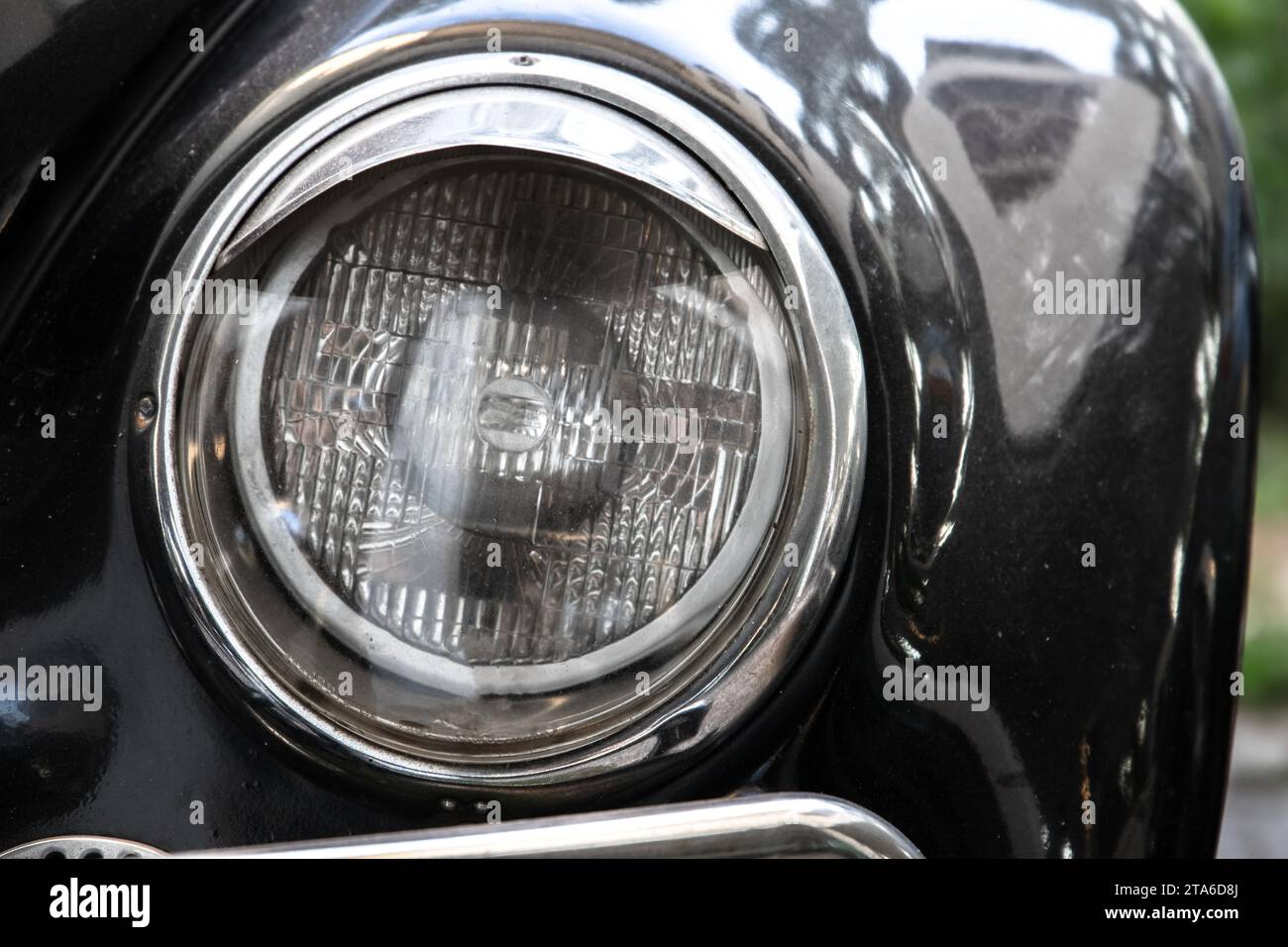 Classic round headlight of an old timer car, front view. Close up photo ...