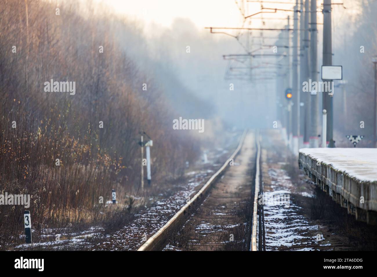 Rural landscape with an empty railway track and station platform in the ...
