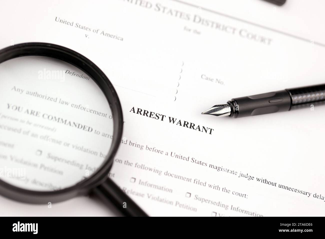 District Court Arrest Warrant court papers on A4 tablet lies on office ...
