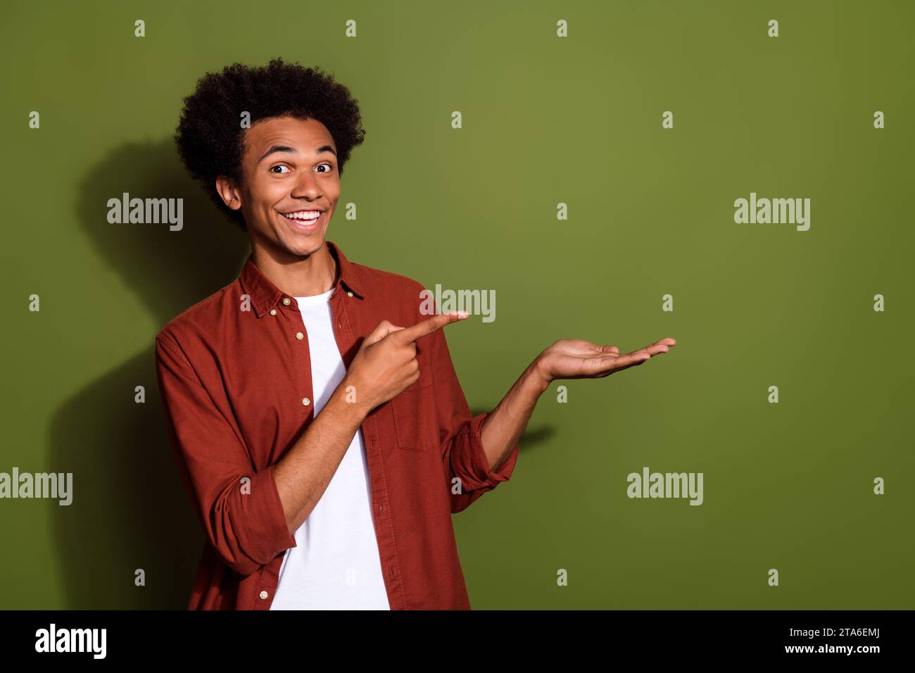 Portrait of good mood guy with chevelure wear stylish shirt indicatign ...