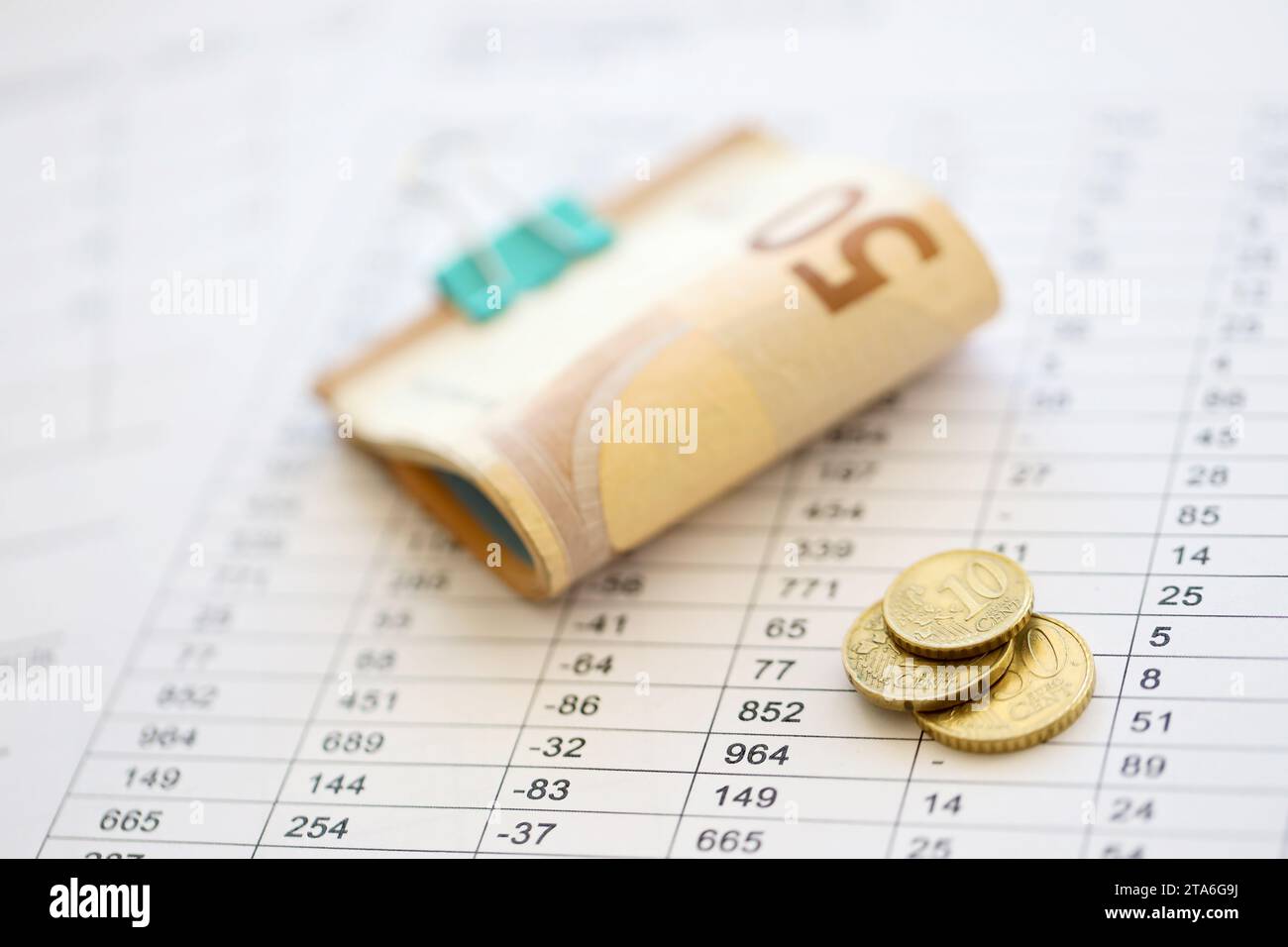 Heap of euro money bills in stationery clip on papers with calculations ...
