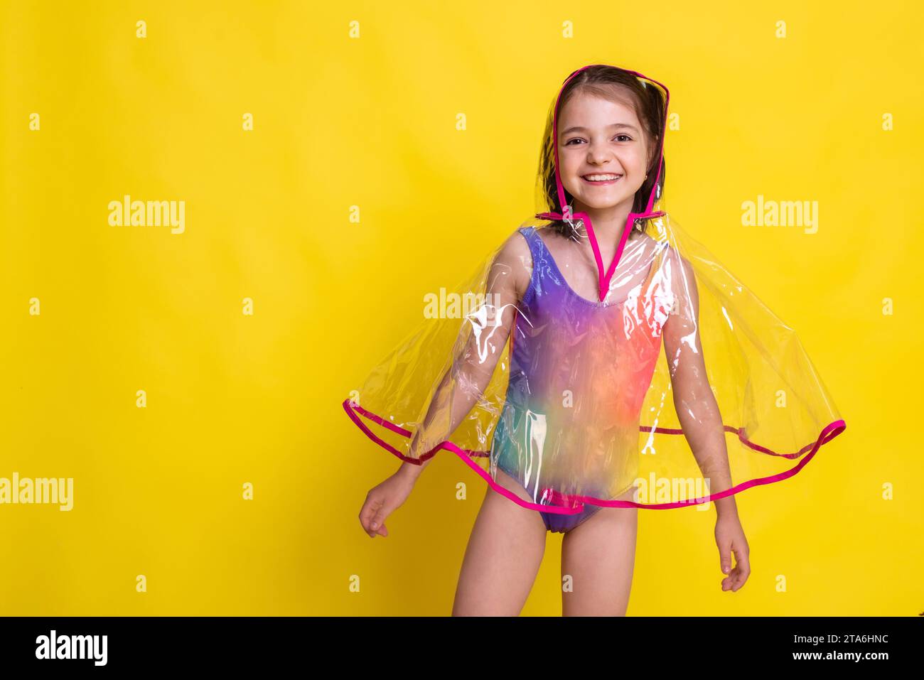 Chic protection, child girl dazzles in transparent raincoat and ...