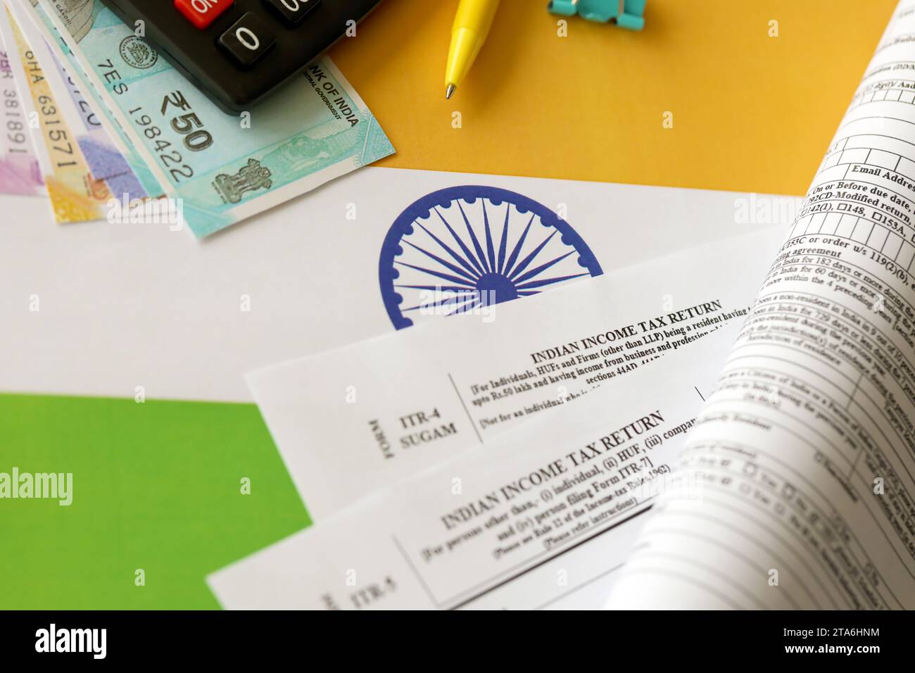 Indian income tax return blank form with pen and indian rupees bills on ...