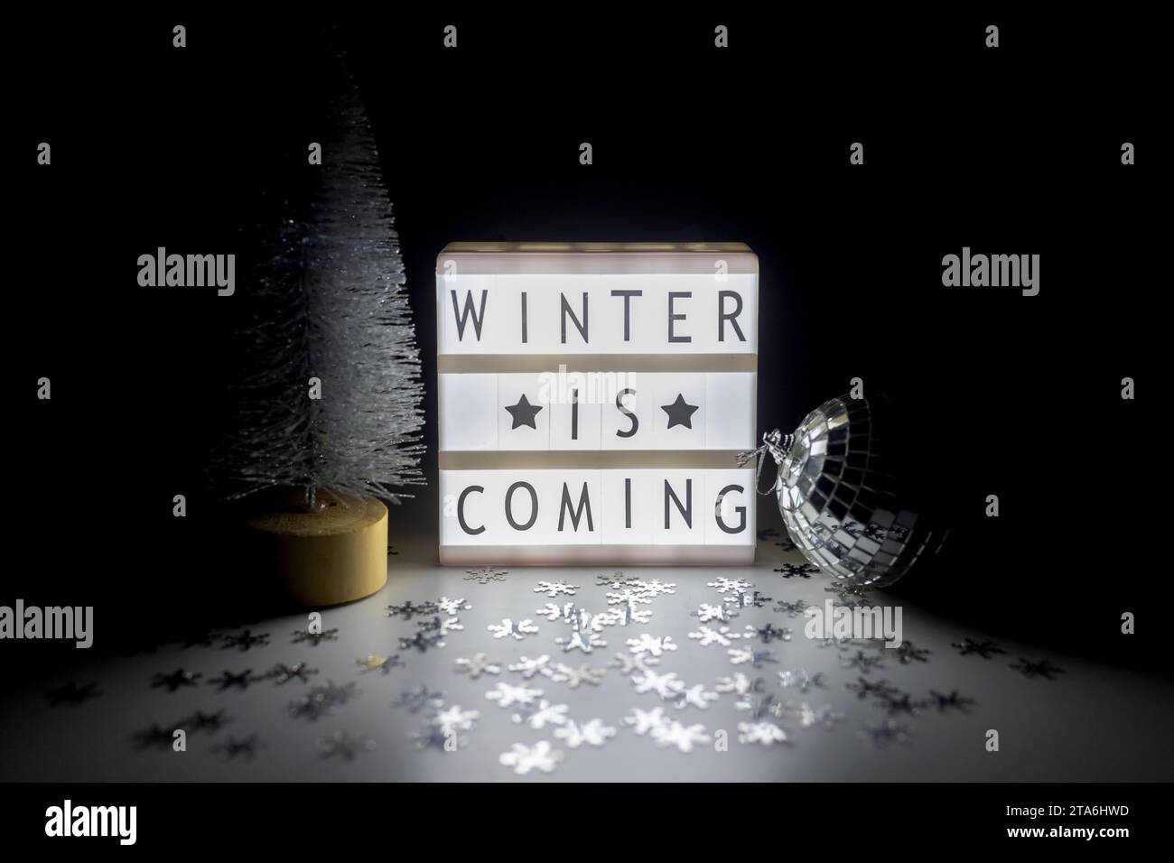 Still life with a silver Christmas tree, a disco ball and a lightbox ...