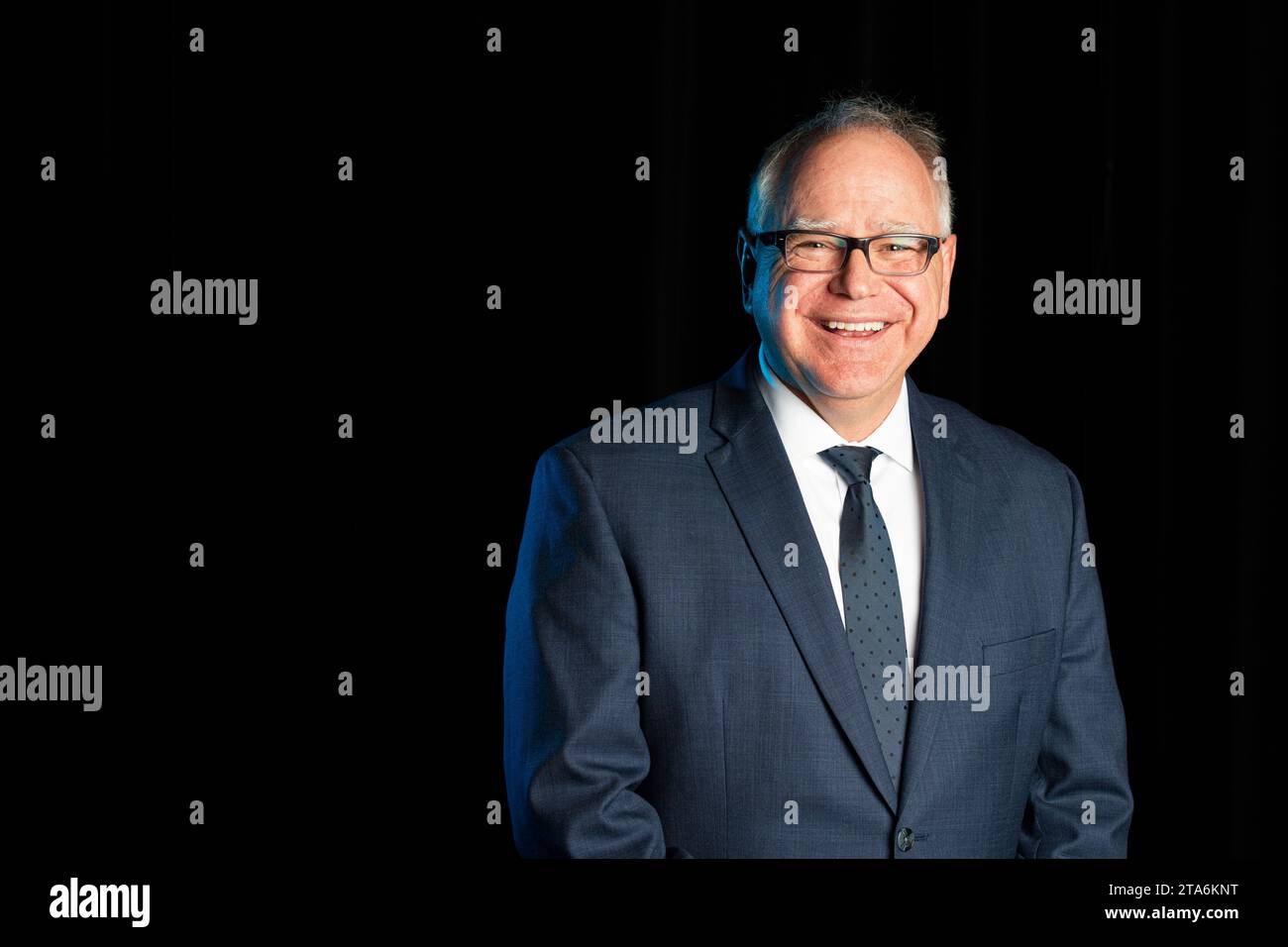 Minnesota Governor Tim Walz lit portrait with black background and blue ...
