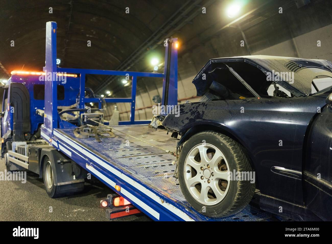 Tow truck loading a crashed car with a crumpled bumper Stock Photo - Alamy