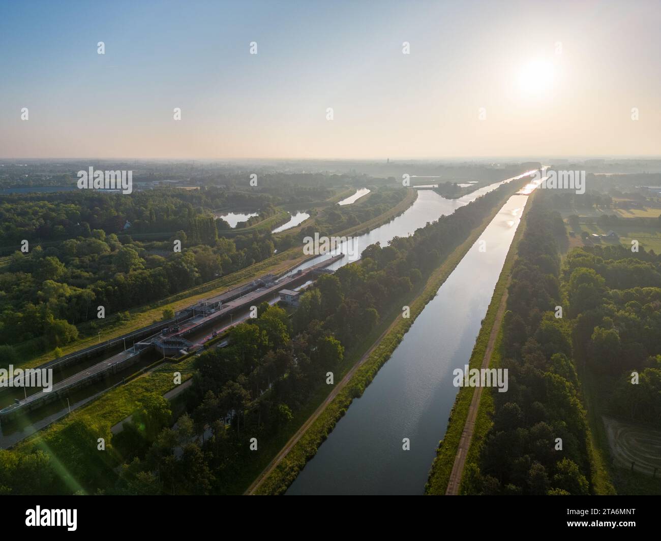This image captures a breathtaking aerial view of a canal at sunrise ...