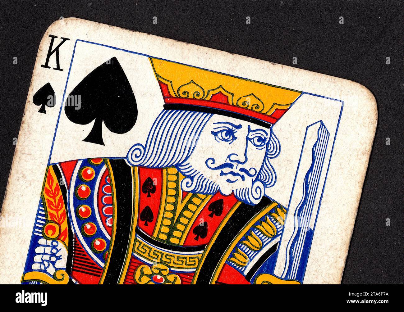 Close up of a vintage king of spades playing card isolated on a black ...