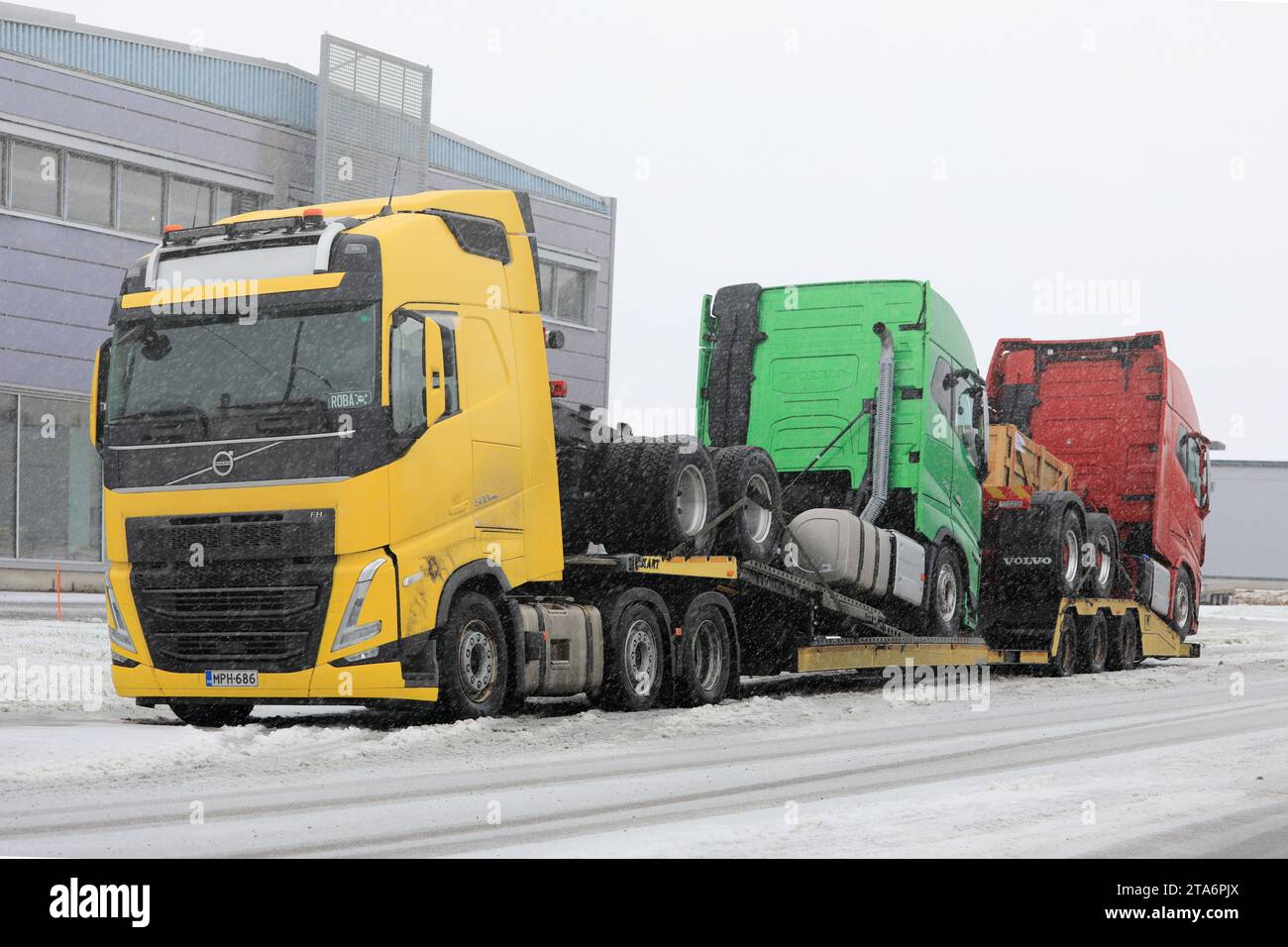 Yellow Volvo FH vehicle carrier truck carrying two new green and red ...
