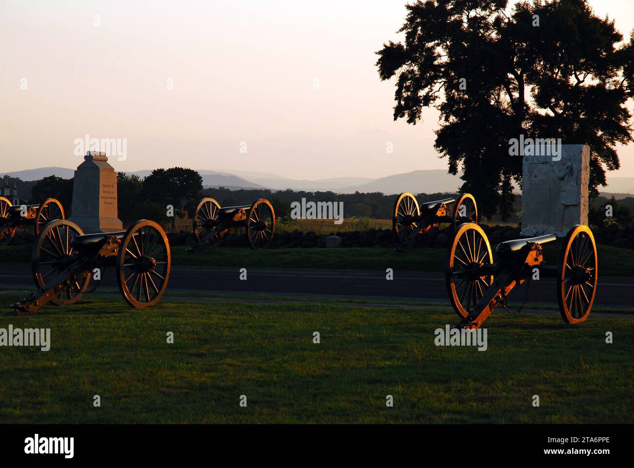 The sun sets on the cannons, artillery and monuments of Gettysburg ...