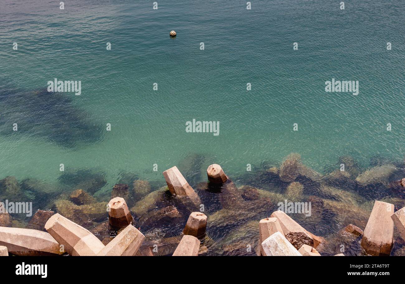 Panoramic photo of sea ocean coastline concrete wave breakers at ...
