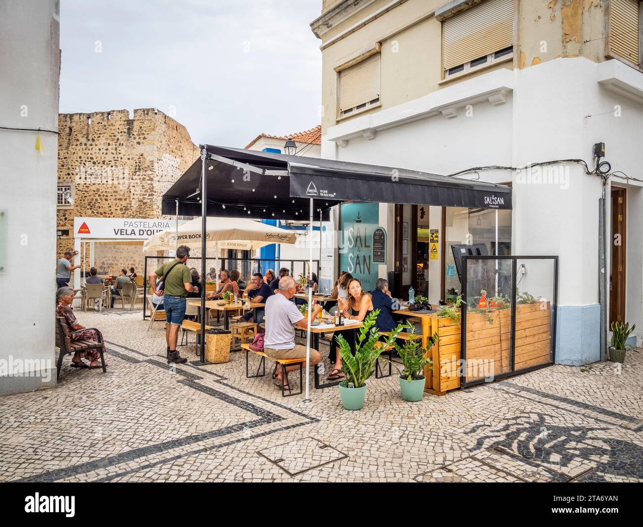 People at an outdoor cafe on the streets of Sines in Portugal Stock ...
